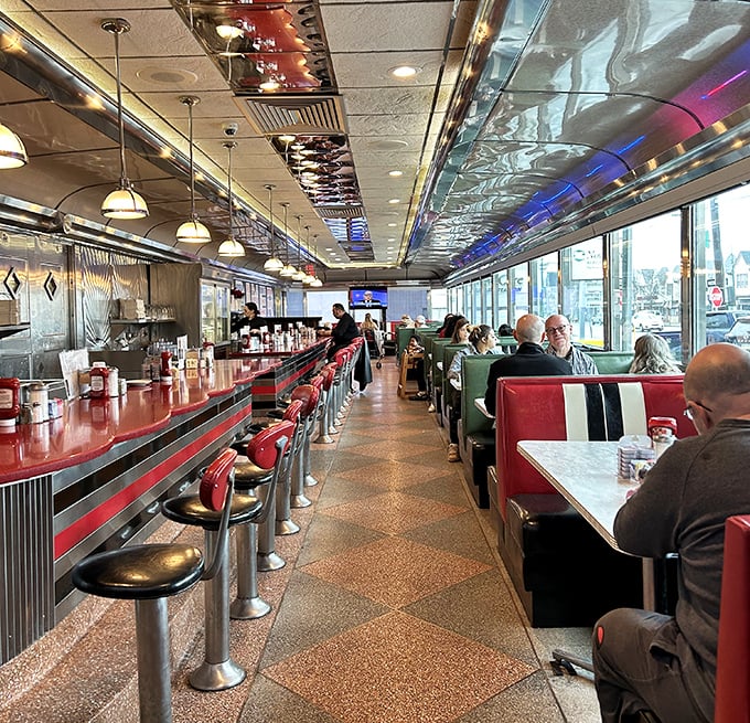Classic Americana in full swing—red vinyl booths, chrome accents, and a counter where strangers become friends over coffee that never stops flowing.