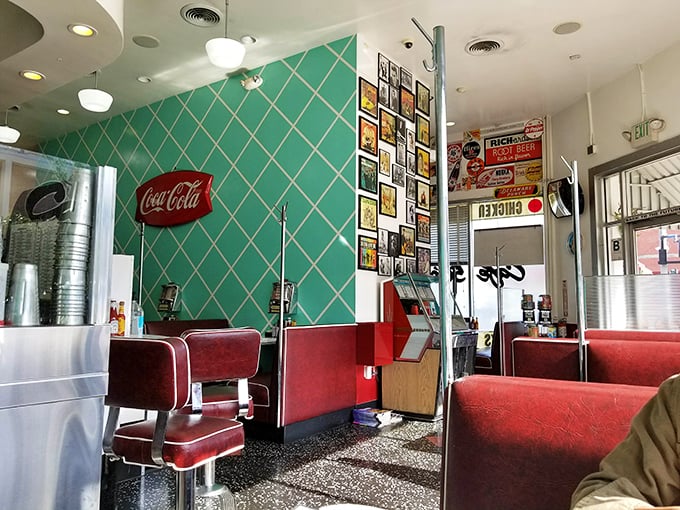 Those turquoise diamond-patterned walls and cherry-red vinyl booths aren't just decoration—they're a portal to when "going steady" was the relationship status update of choice.