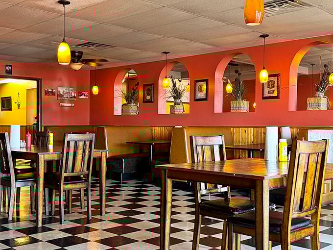 Coral walls, pendant lighting, and that classic checkered floor create the perfect backdrop for burger bliss. This isn't Instagram-bait décor; it's the real-deal comfort zone.