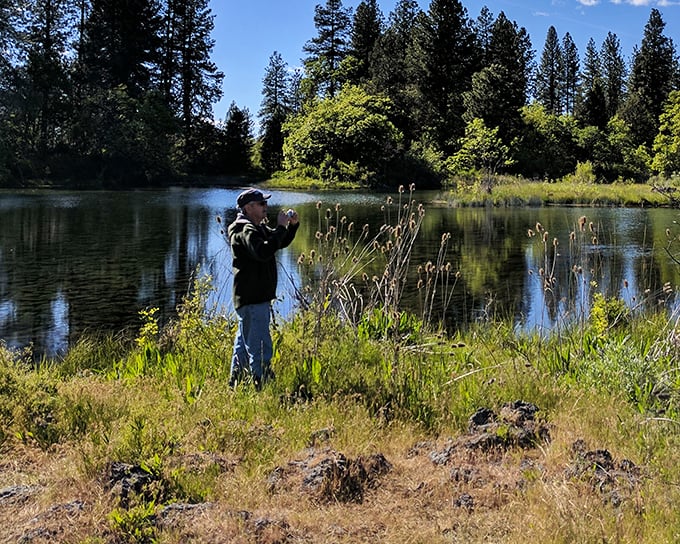 The photographer becomes the subject as pristine waters and towering pines create a backdrop worthy of a National Geographic cover.