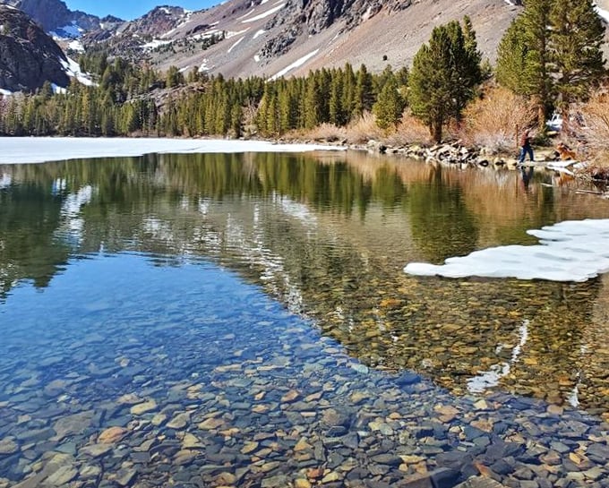 Crystal clear waters at Lake Sabrina mirror the rugged mountains, creating nature's perfect infinity pool. Trout are practically begging to be caught here.