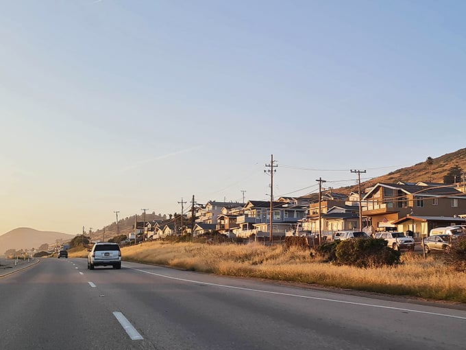 Highway 1 whispers promises of small-town charm as golden hour bathes these hillside homes in California dreaming.