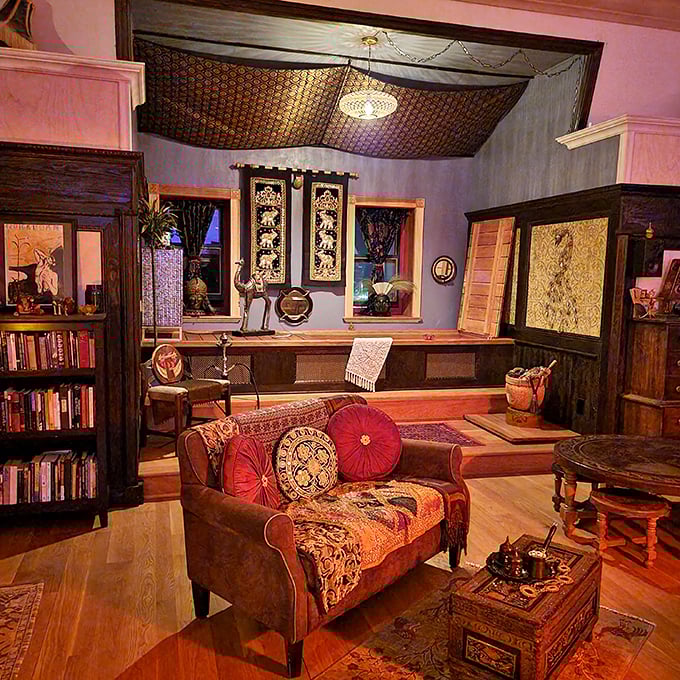 Step into this Moroccan-inspired living room where vibrant textiles and warm lighting create an atmosphere that's both exotic and eerily inviting.