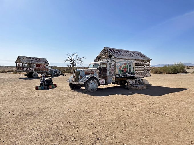 Parked in the desert like time travelers from another era, these painted vehicles serve as quirky sentinels guarding the approach to Salvation Mountain.