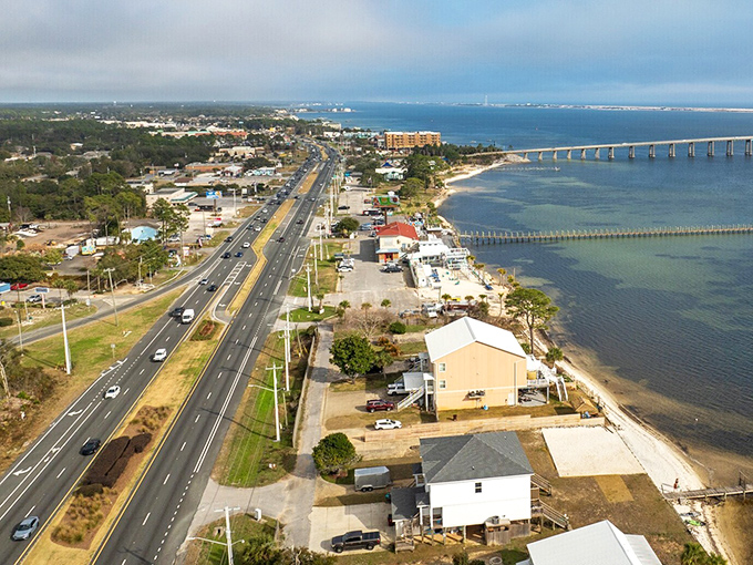 Highway 98 cuts through Navarre like a lifeline, connecting beach homes to mainland amenities with the stunning Navarre Beach Bridge in view.
