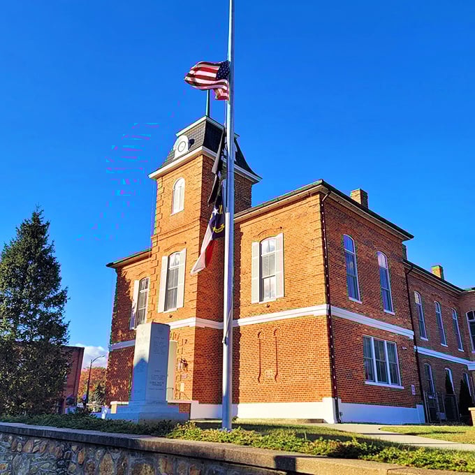 The historic Transylvania County Courthouse stands proudly under Carolina blue skies, its brick façade and clock tower a timeless anchor in downtown Brevard.