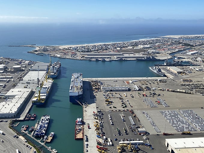 The deep-water port isn't just functional—it's fascinating. Container ships and naval vessels create a maritime ballet that's surprisingly mesmerizing from this bird's-eye perspective.