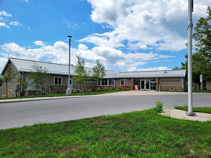 The park office welcomes visitors with its rustic stone-and-timber charm – nature's reception desk where adventures begin and maps mysteriously disappear from pockets.