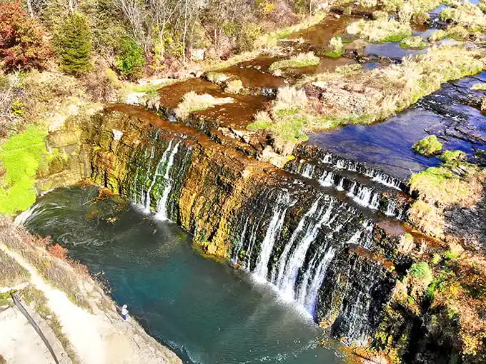 Nature's staircase caught mid-descent. The falls create a mesmerizing rhythm as water dances over ancient rock formations, each drop telling a geological story.