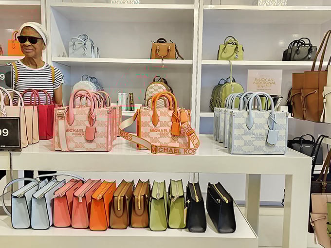 A rainbow of Michael Kors handbags awaits, arranged with the precision of a military operation. Your credit card may never forgive you.