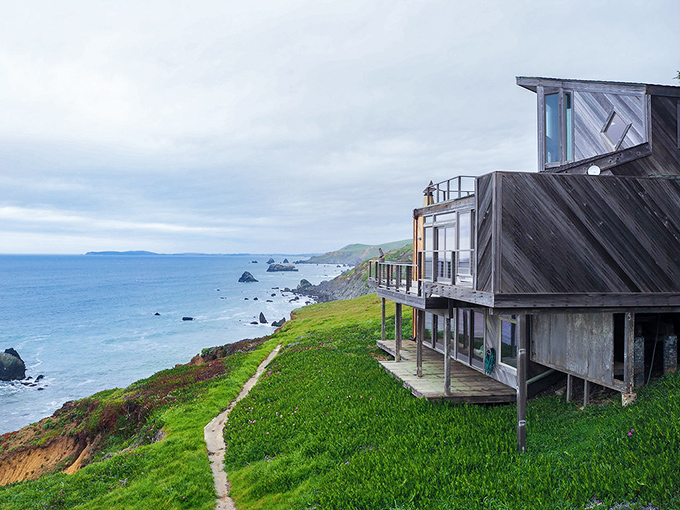 Coastal living at its finest—weathered wood meets panoramic views in these cliffside homes where every window frames a postcard-worthy scene.