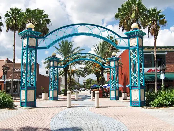 Stroll through these whimsical turquoise arches and suddenly you're not just shopping—you're on a Florida adventure where palm trees are your companions.