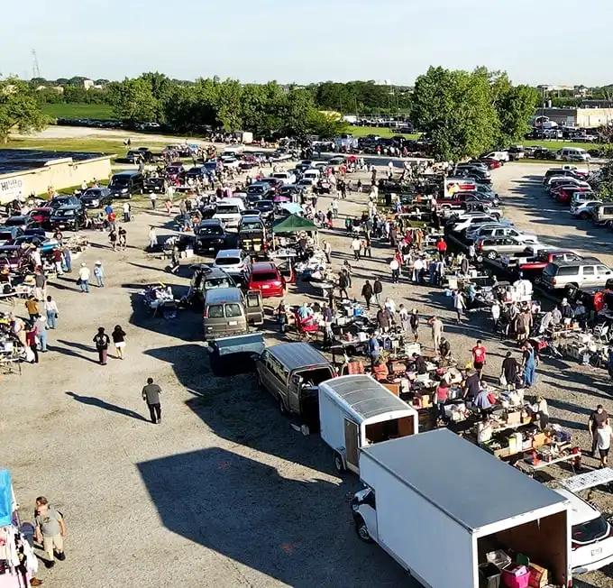 The aerial view reveals the true scale of this bargain hunter's paradise, where hundreds gather in a ritual as old as commerce itself.