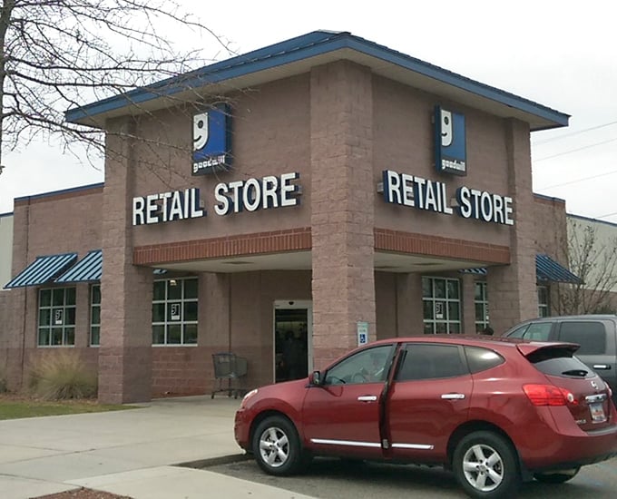 Blue awnings and brick façade give this thrift paradise a surprisingly upscale look. The red car out front? Someone smart enough to know where the deals live.