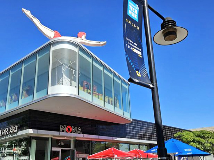 The iconic red diver perched atop MONA serves as both landmark and metaphor—inviting visitors to take the plunge into a sea of neon wonders.