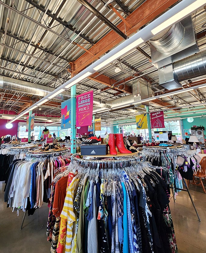 Beneath industrial ceilings, a rainbow of clothing awaits. Those red boots are practically screaming, "Try me on!"