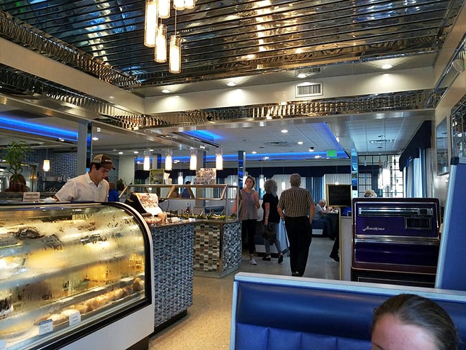Inside, chrome meets cozy as the diner's polished interior whispers promises of hearty meals and bottomless coffee refills under that classic stainless steel ceiling.