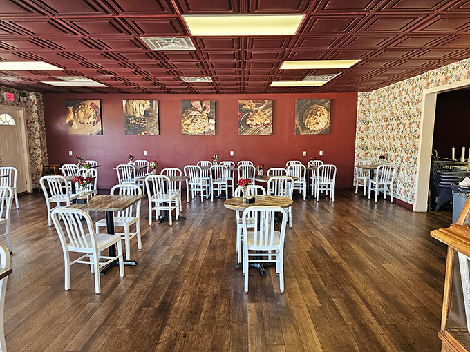 Burgundy walls adorned with pie portraits create a shrine to flaky perfection. The white chairs aren't just furniture—they're front-row seats to one of Missouri's greatest culinary performances.