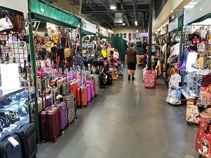 Luggage paradise awaits! Rows of colorful suitcases line this aisle, perfect for those who need something to carry home all their newfound treasures.