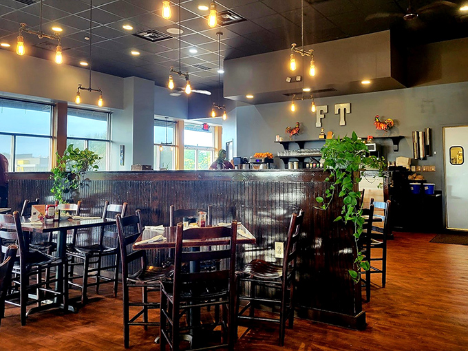 Modern pendant lighting casts a warm glow over wood-paneled walls and cozy seating. The kind of place where breakfast dreams are hatched and coffee cups never empty.