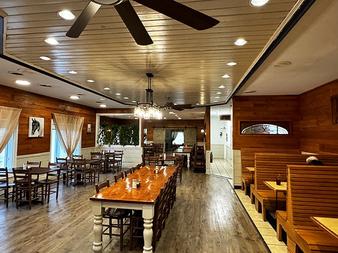 Warm wooden walls, ceiling fans, and that long communal table – this isn't just a restaurant, it's South Carolina's living room.