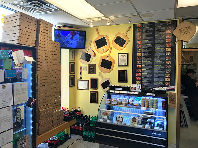 Inside, yellow walls showcase a treasure trove of awards. When a pizzeria displays this many accolades, your taste buds should start paying attention.
