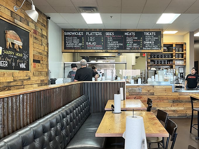 Rustic wood, corrugated metal, and that chalkboard menu—this isn't just decor, it's a barbecue manifesto. Simple surroundings let the meat be the star.