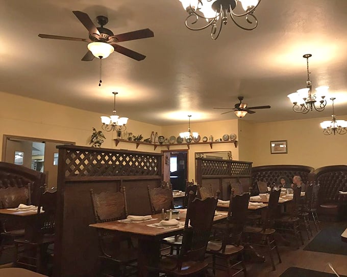 Wooden lattice dividers and warm yellow walls create intimate dining spaces where conversations flow as freely as the coffee refills.