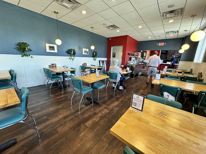 Retro turquoise chairs and blue walls create the perfect backdrop for barbecue bliss. No distractions, just you and that brisket—as it should be.