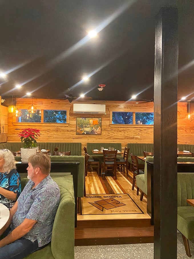 Inside, warm wood tones and green banquettes create the perfect "come as you are" steakhouse atmosphere.