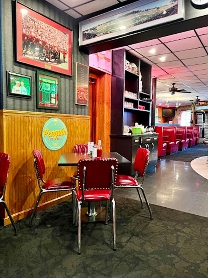Those cherry-red vinyl booths aren't trying to be retro-cool—they're the real deal, worn in all the right places from decades of satisfied customers.