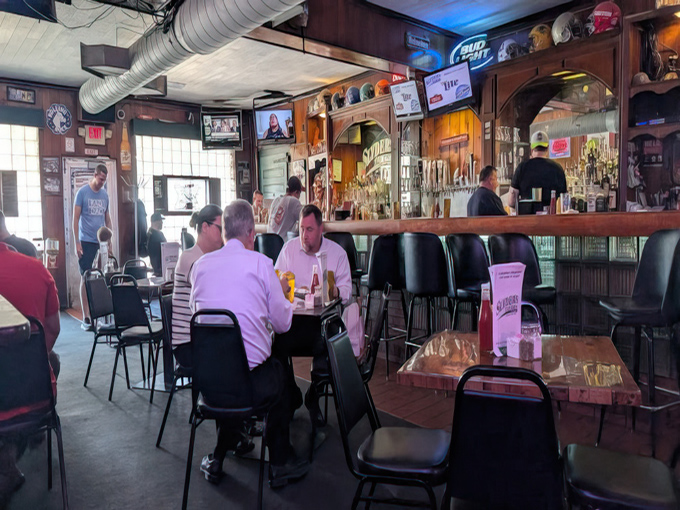 Inside, time stands still in the best possible way—wood paneling, comfortable seating, and the unmistakable buzz of people united by great food.