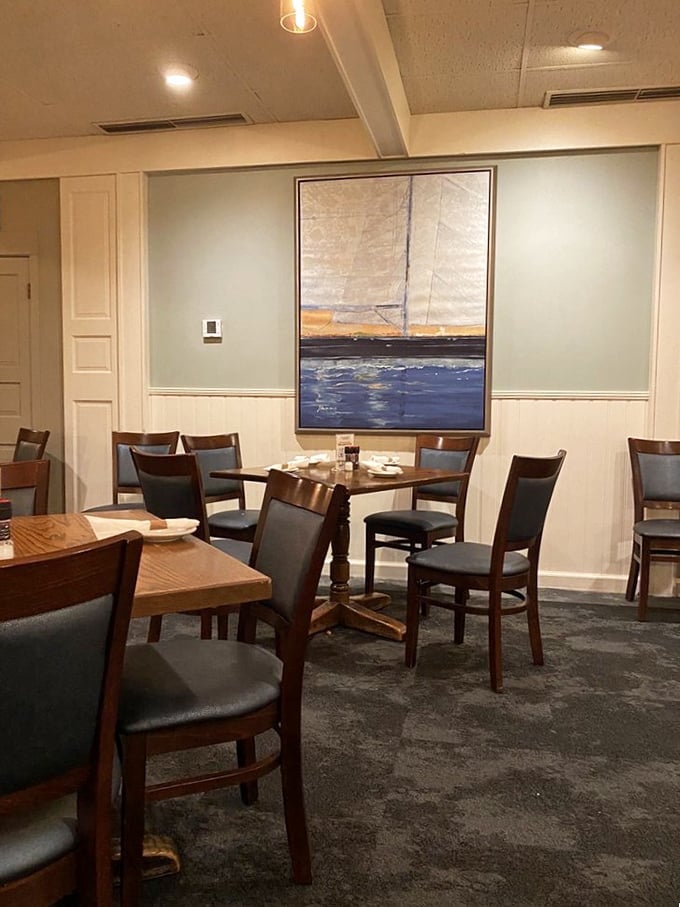 Maritime artwork watches over diners like a benevolent sea captain, while the blue and white color scheme transports you to coastal New England without the eight-hour drive.