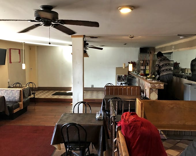 Simple tables, ceiling fans, and no-nonsense decor tell you everything you need to know: this place puts its energy where it matters—in the kitchen.