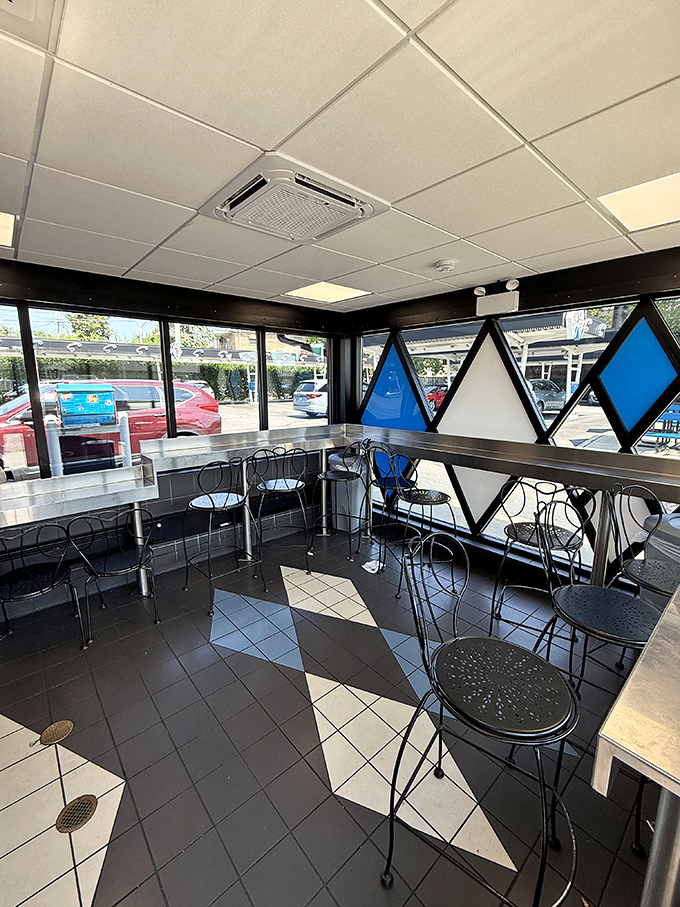 The classic blue and white diamond pattern continues inside, where vintage wire chairs invite you to savor your meal like it's 1955.