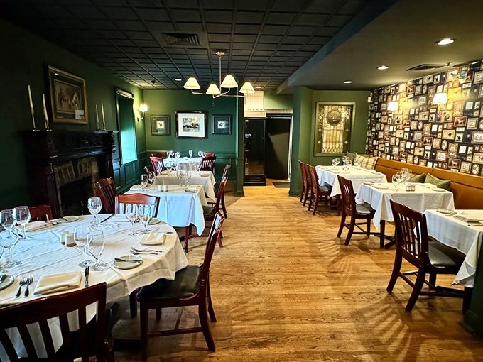 Green walls, white tablecloths, and that wall of memories—dining rooms like this are where celebrations become stories we tell for years.