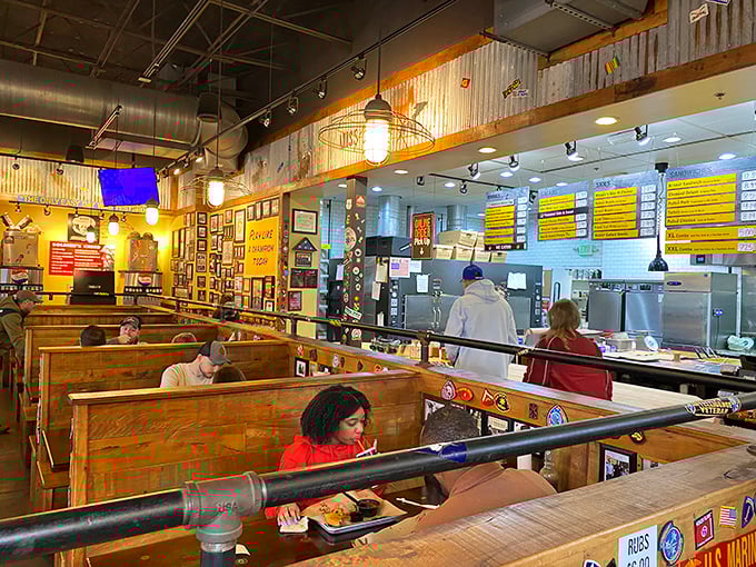 Church pew-style seating and industrial lighting create a sanctuary of smoke where BBQ devotees commune over trays of meaty perfection.