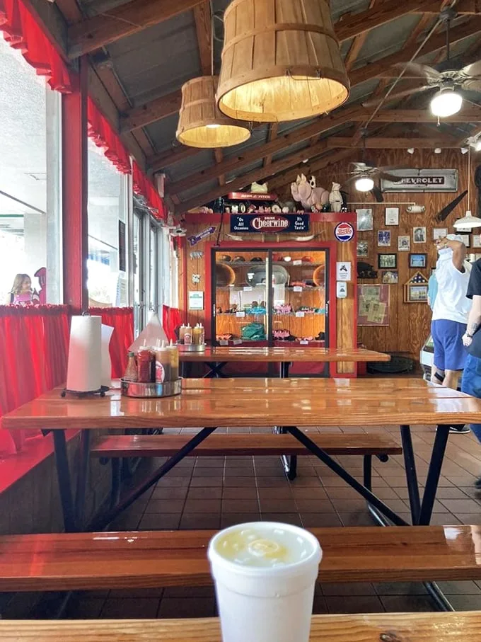 Wooden barrel lampshades and red checkered curtains set the stage for meat-centric memories. This isn't décor—it's BBQ theater in its most authentic form.