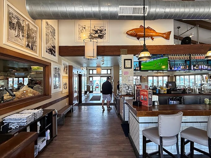 Inside, nautical charm meets casual elegance. That wooden fish overhead isn't just decoration—it's practically the maitre d' of this seafood sanctuary.