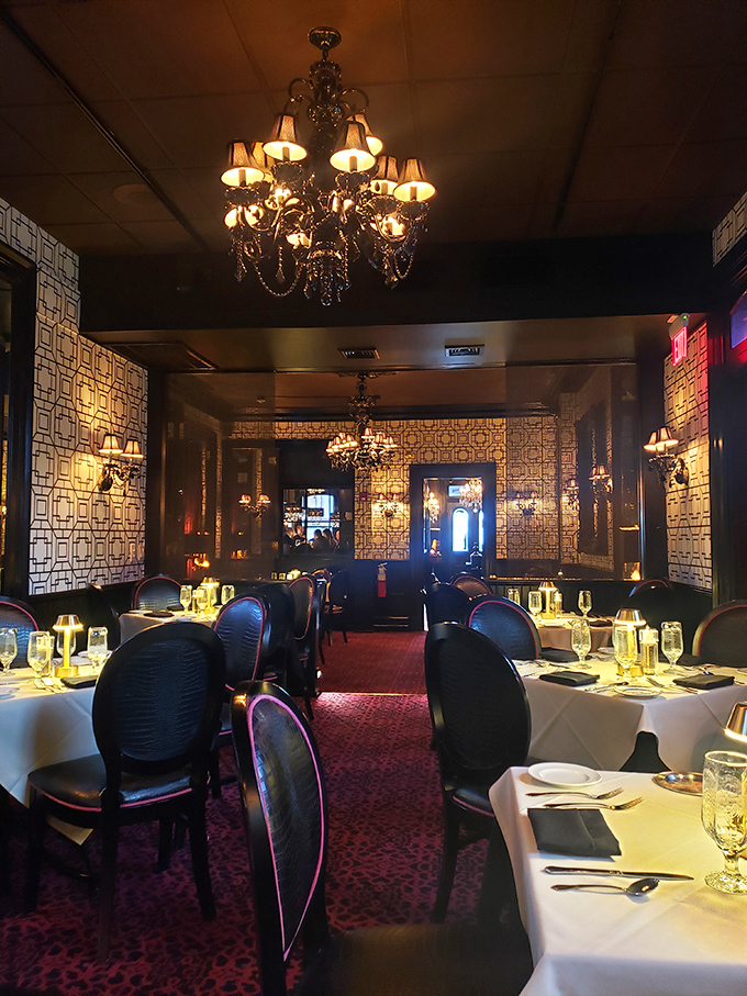 Chandeliers cast a golden glow over crisp white tablecloths and plush chairs. Dining here feels like stepping into a more glamorous era.