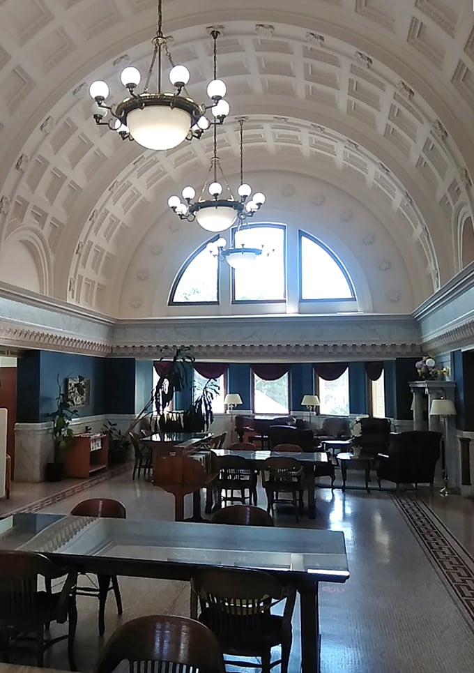 Beneath this spectacular barrel-vaulted ceiling, readers find sanctuary. The elegant chandeliers cast a warm glow that makes even classic literature seem more inviting.