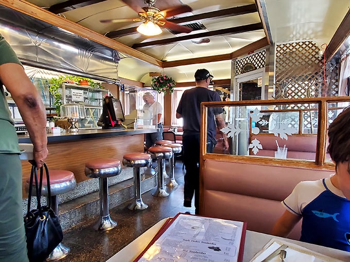 Classic Americana at its finest—chrome counter stools, lattice dividers, and vinyl booths create the perfect backdrop for comfort food conversations.