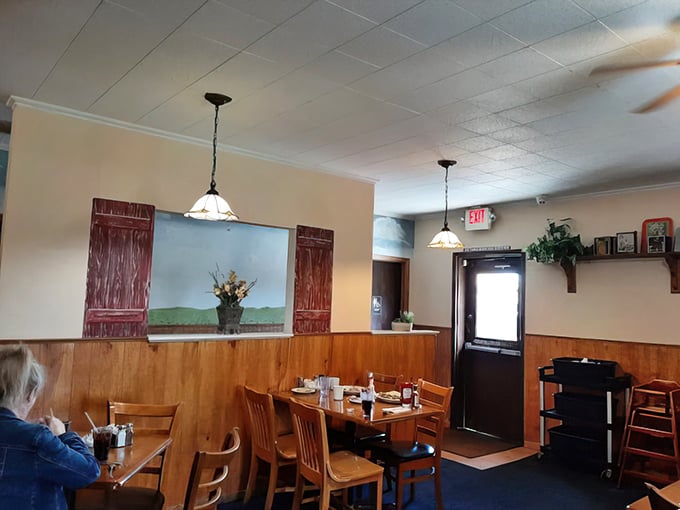 Wooden paneling and simple pendant lights create that rare atmosphere money can't buy—genuine small-town cafe warmth.