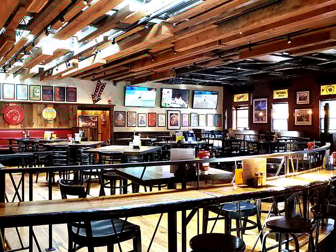 Wooden beams stretch across the ceiling like an architectural high-five, creating the perfect backdrop for cold beers and warm conversations.