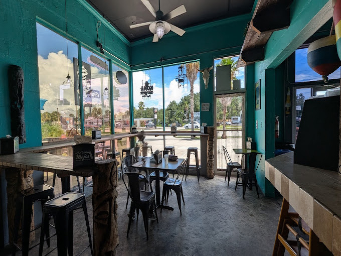 Step inside to a turquoise paradise where industrial-chic meets coastal cool—the perfect backdrop for your taco adventure.