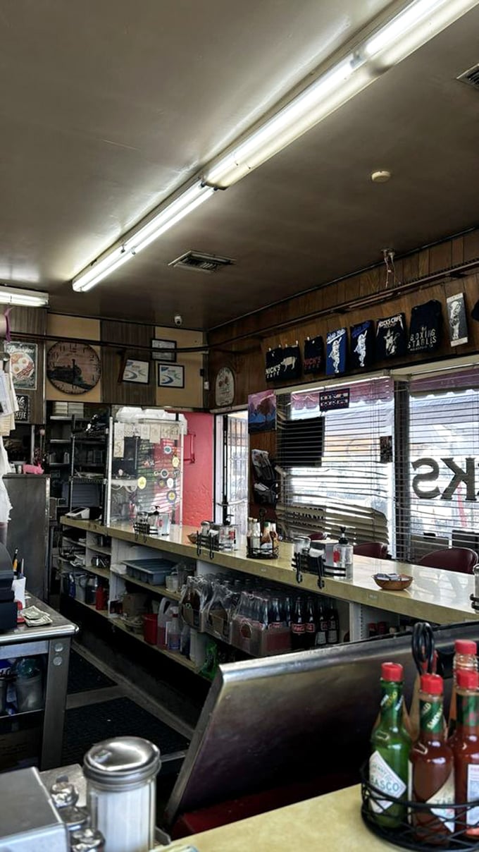 Behind the counter is where the magic happens—fluorescent lights illuminating decades of breakfast craftsmanship in this no-frills temple to morning meals.