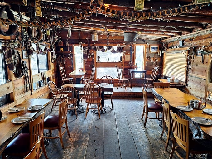 Inside, cowboy artifacts dangle from rough-hewn beams while simple wooden tables await their next feast. This isn't décor—it's genuine frontier heritage.