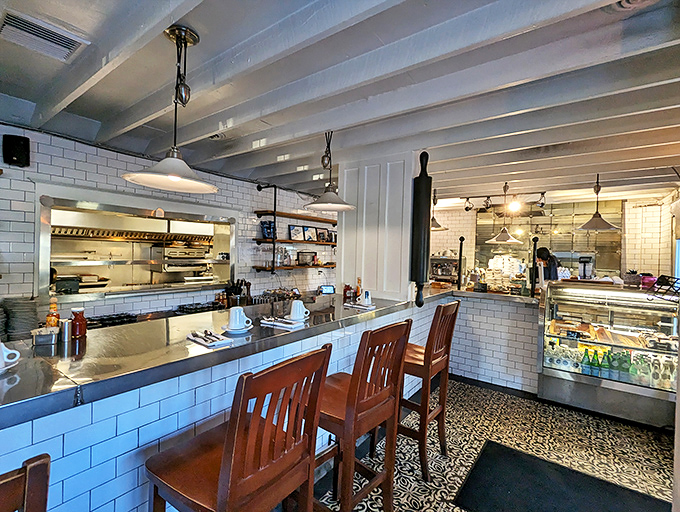 Counter seating that puts you front-row for the breakfast ballet—where subway tiles and wooden chairs create the perfect backdrop for morning magic.