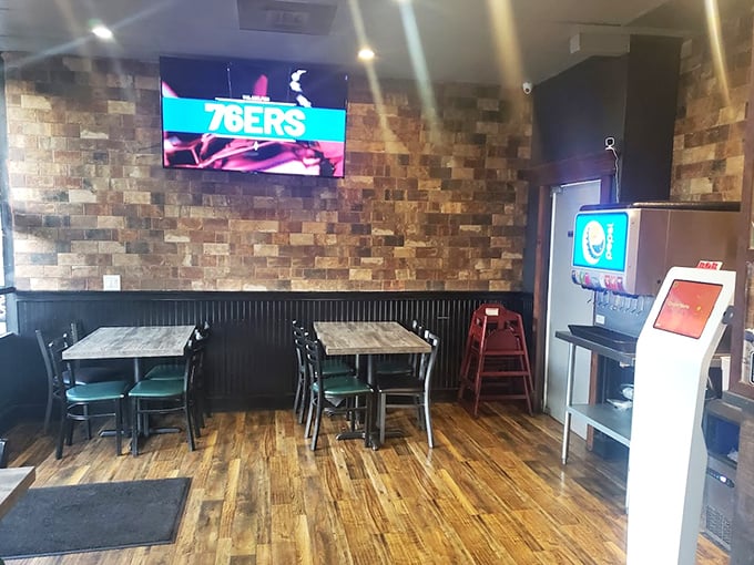 Simple tables, stone walls, and a TV showing the game—this is where food matters more than frills.