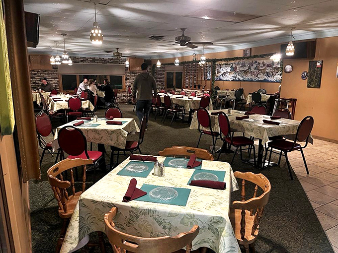 Step inside to a dining room where time slows down—red chairs, patterned tablecloths, and brick walls creating that irreplaceable Wisconsin supper club magic.